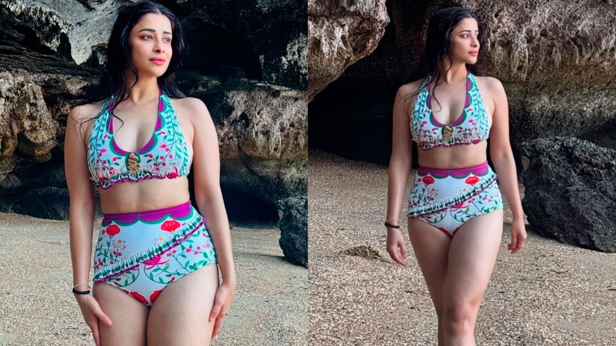 Nyra Banerjee stuns in a vibrant floral bikini against a rocky beach backdrop